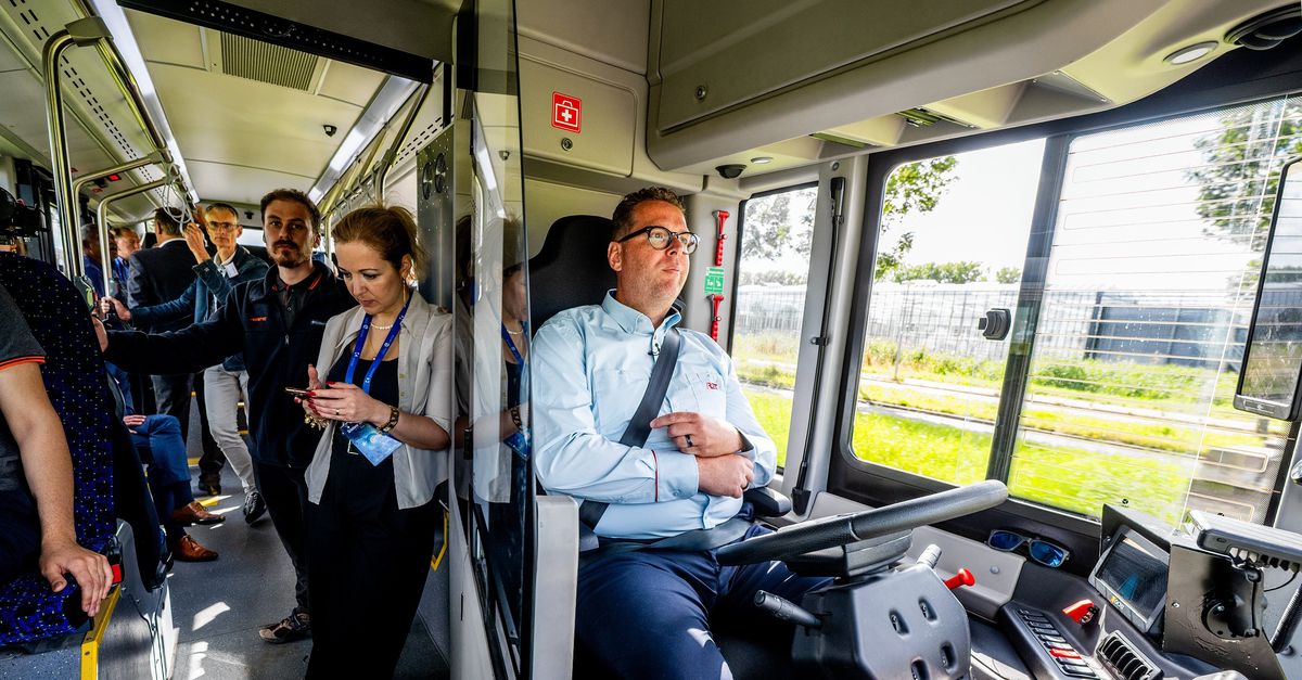 The robot bus is parked neatly next to the sidewalk. "You don't see a ...
